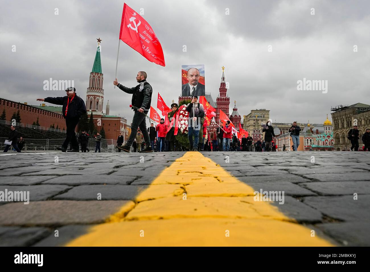 Russian communists and supporters with red flags and a portrait of ...