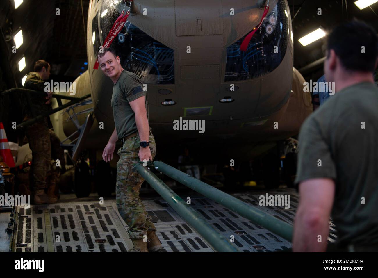 Australian Army soldiers load a CH-47F Chinook helicopter tow bar onto ...