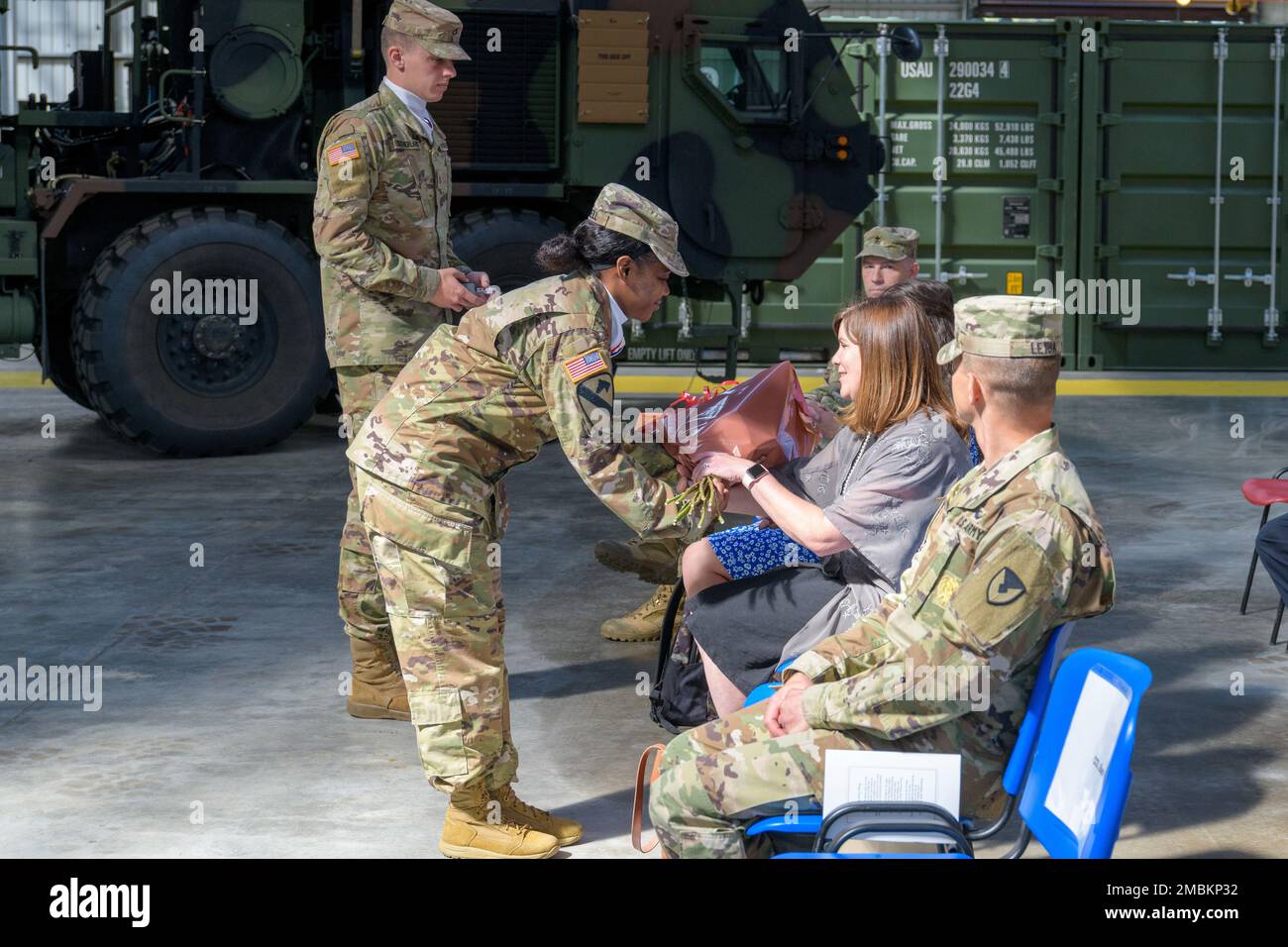 Mrs. Jena Jones, spouse of Lt. Col. Aaron L. Jones, receives a bouquet ...
