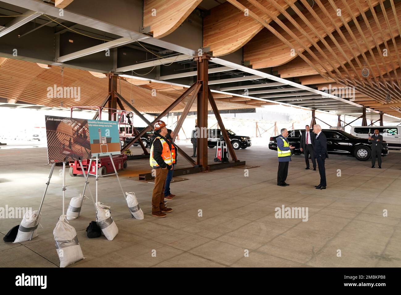 President Joe Biden listens as he tours a construction area at Portland ...