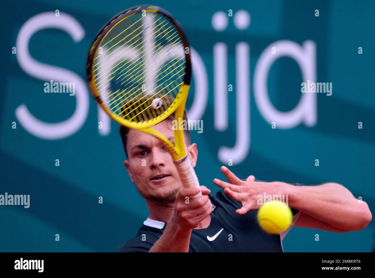 Miomir Kecmanovic of Serbia returns a ball to Novak Djokovic of Serbia during their quarter ...