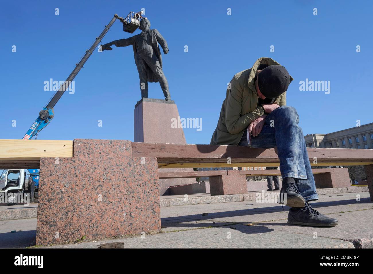 A man sleeps sitting on the bench as a worker of the Museum of Urban ...