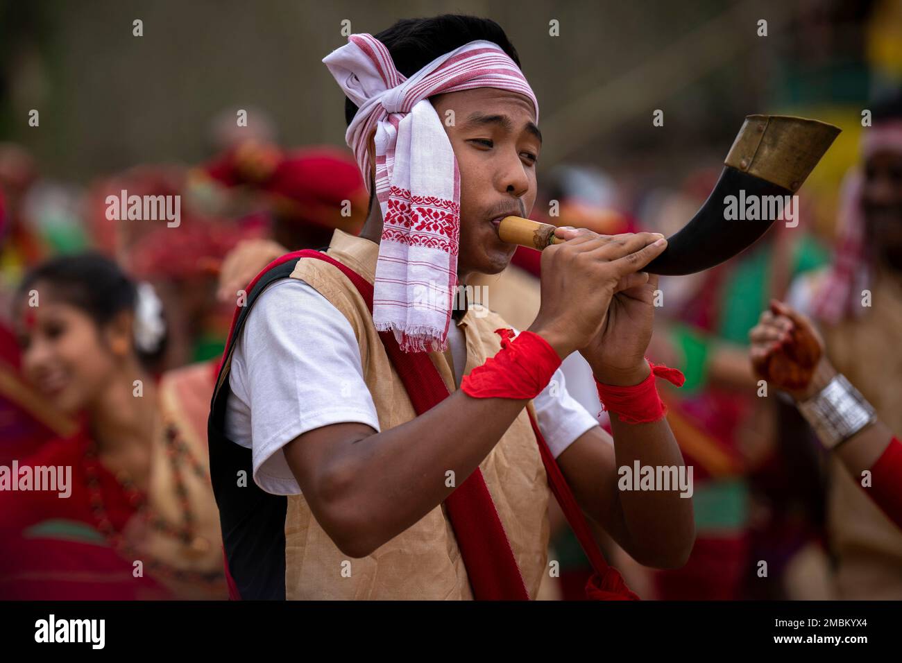 An Assamese boy plays a traditional musical instrument made of buffalo ...