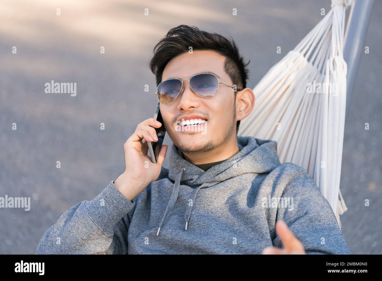 Young man holding mobile phones hi-res stock photography and images - Alamy
