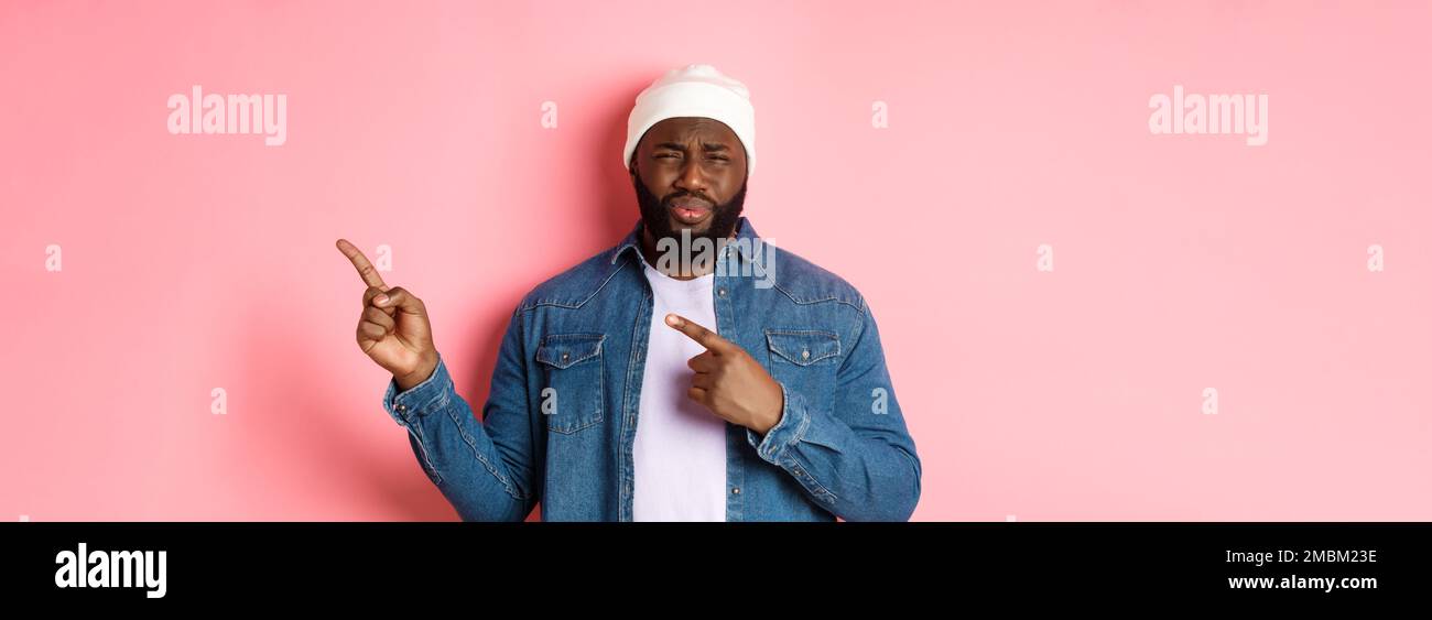 Disappointed and skeptical african-american guy complaining, cringe ...