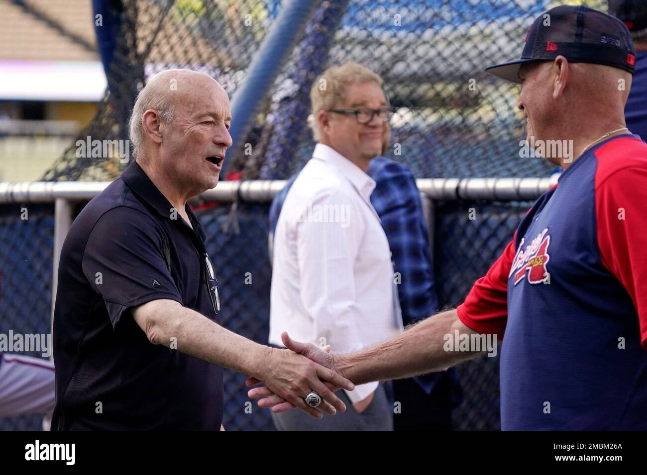 Los Angeles Dodgers co-owner Stan Kasten, left, greets Atlanta Braves ...