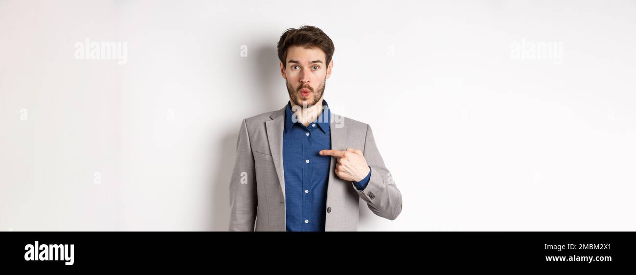 Who me. Surprised man in suit pointing at himself with disbelief ...
