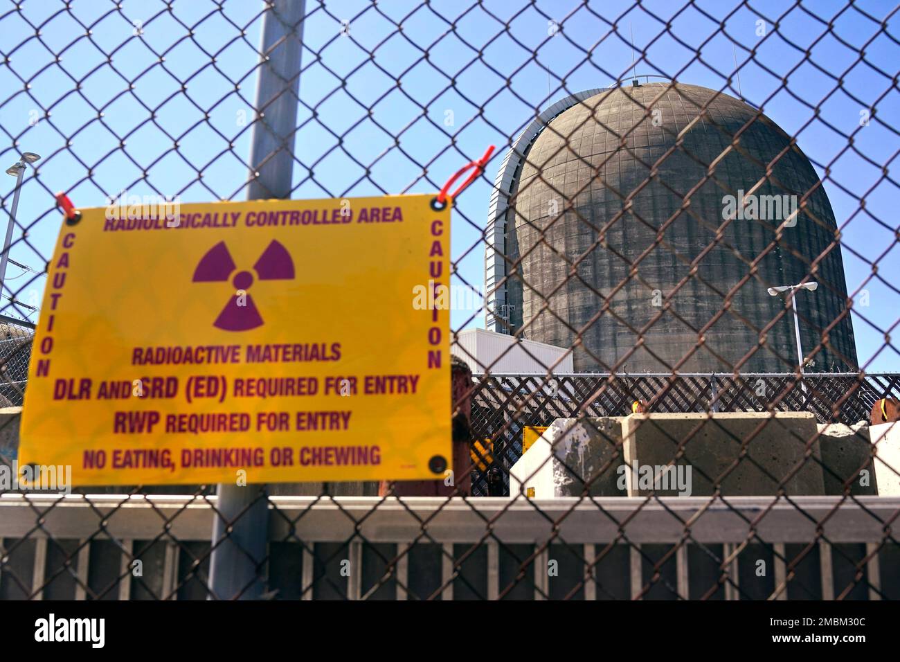 FILE— A sign warning of radioactive materials is seen on a fence around ...