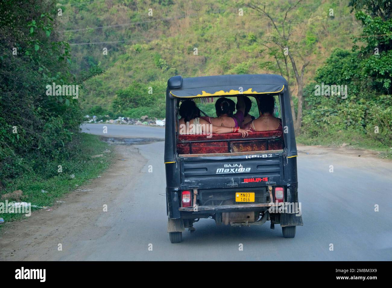Women ride in an auto rickshaw on the outskirts of Imphal, capital of ...