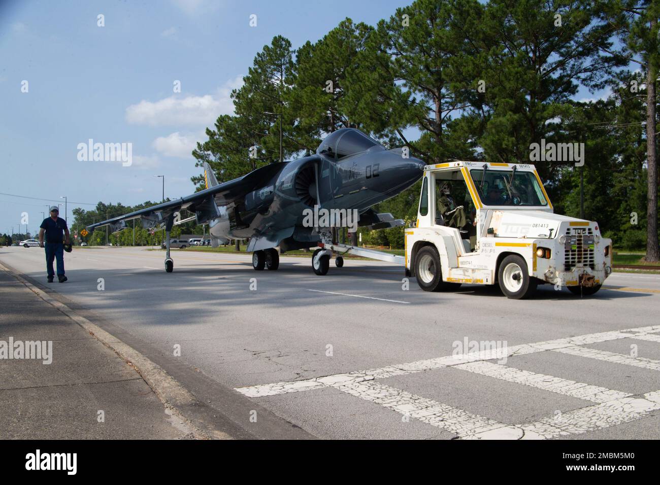 Fleet Readiness Center East contractors escort an AV-8B Harrier II to ...
