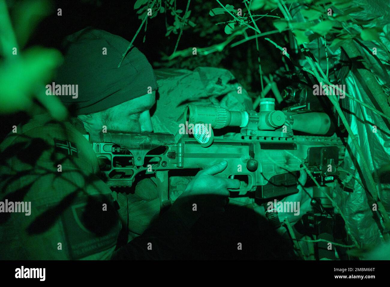 A Norwegian Special Forces Sniper team prepares to fire upon a high ...