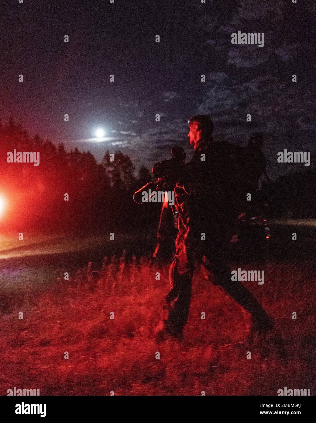 A Greek Special Forces Sniper prepares his gear during a night-time ...