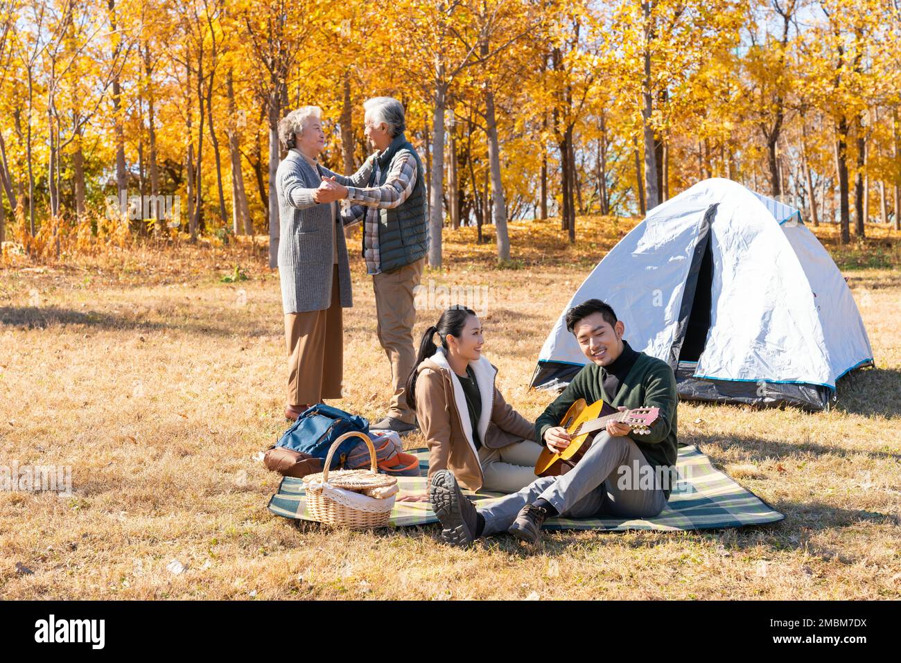 Happy family autumn camping out for a picnic Stock Photo - Alamy