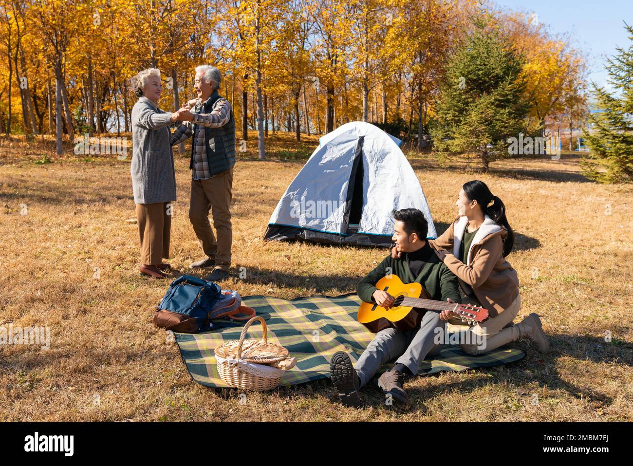 Happy family autumn camping out for a picnic Stock Photo - Alamy