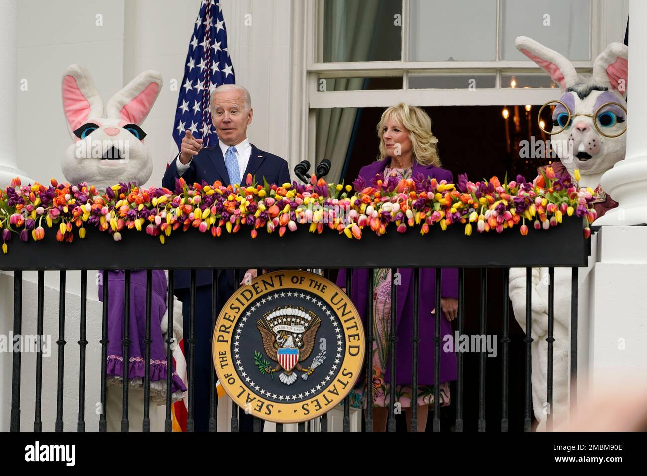 President Joe Biden and first lady Jill Biden, walk out to participate ...