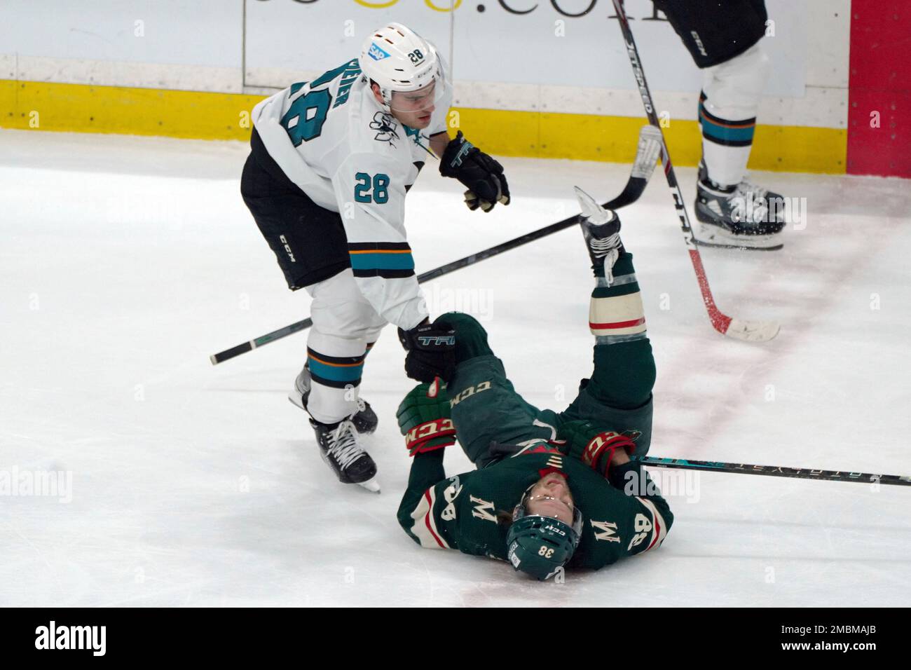 Minnesota Wild's Ryan Hartman gets checked to the ice by San Jose ...