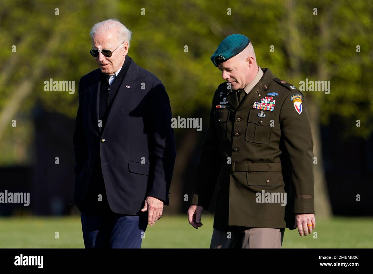President Joe Biden walks to a motorcade vehicle with Col. David ...