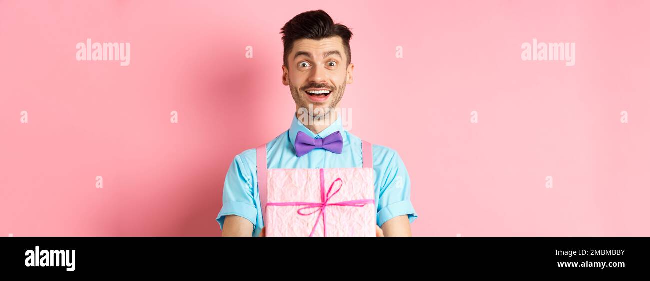 Holidays and celebration concept. Cheerful guy wishing happy birthday ...