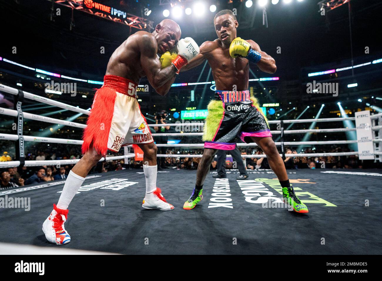 Errol Spence Jr., right, hits Yordenis Ugas, from Cuba, during a ...