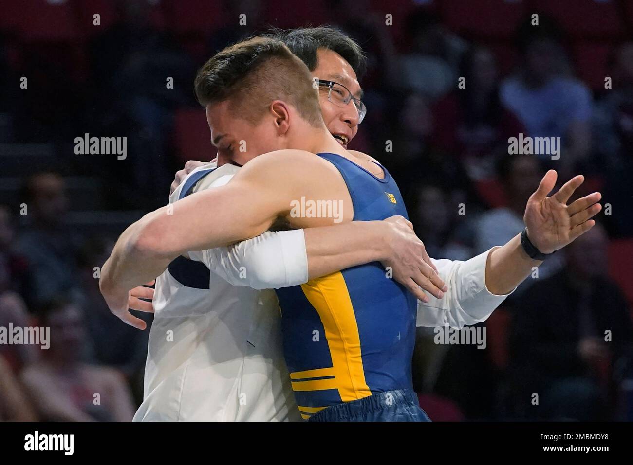 Michigan's Paul Juda celebrates with interim coach Yuan Xiao after ...