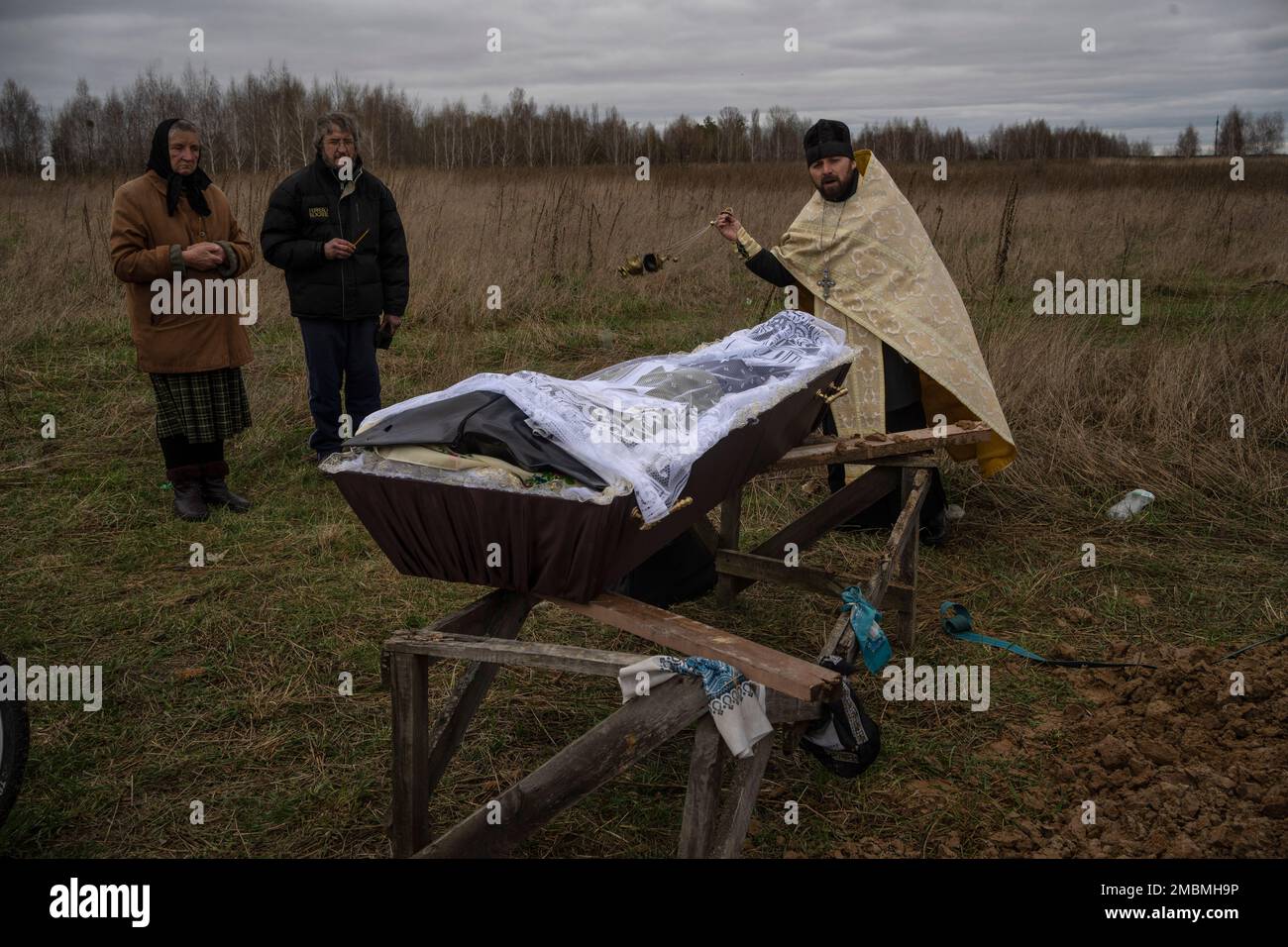 Nadiya Trubchaninova, 70, center, and her son Oleg, 46, attend the funeral of her son Vadym, 48 ...