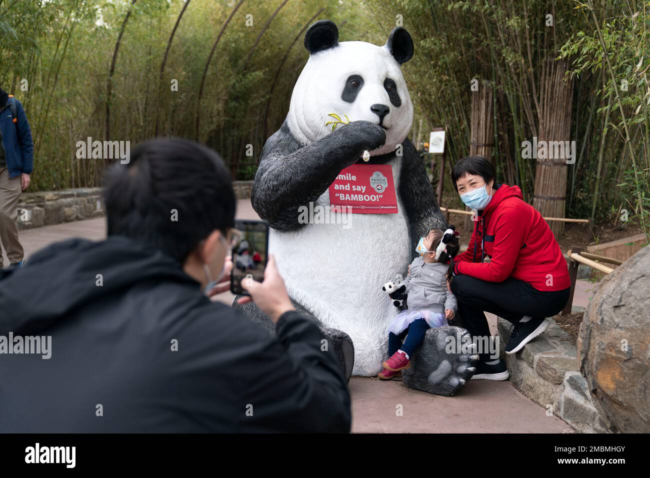 Visitors take pictures with a giant panda statue during the celebration ...
