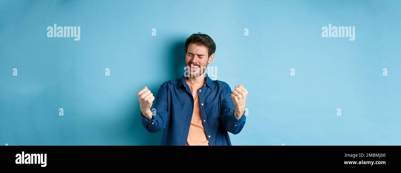 Image of happy man celebrating success, shouting yes and shaking ...