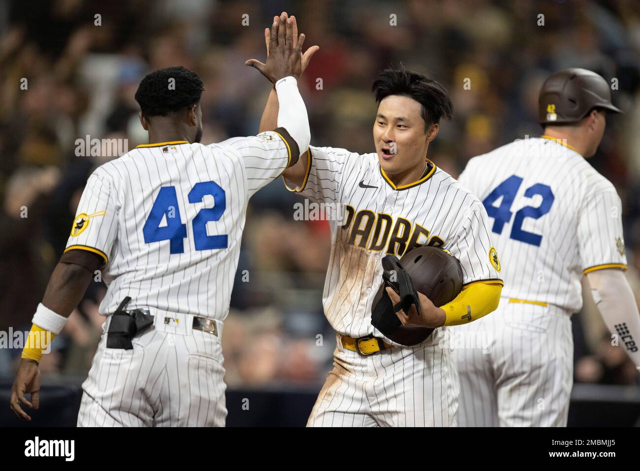 San Diego Padres' Ha-Seong Kim, center, celebrates after scoring with ...