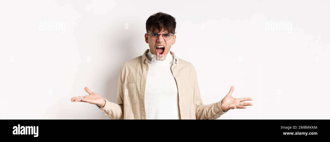 Portrait of angry frustrated man shouting and having argument, spread ...
