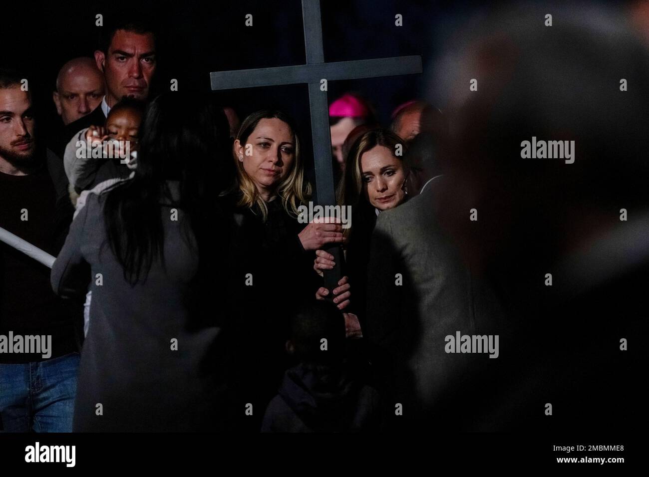 Two nurses from Russia and Ukraine hold the cross as they take part in ...