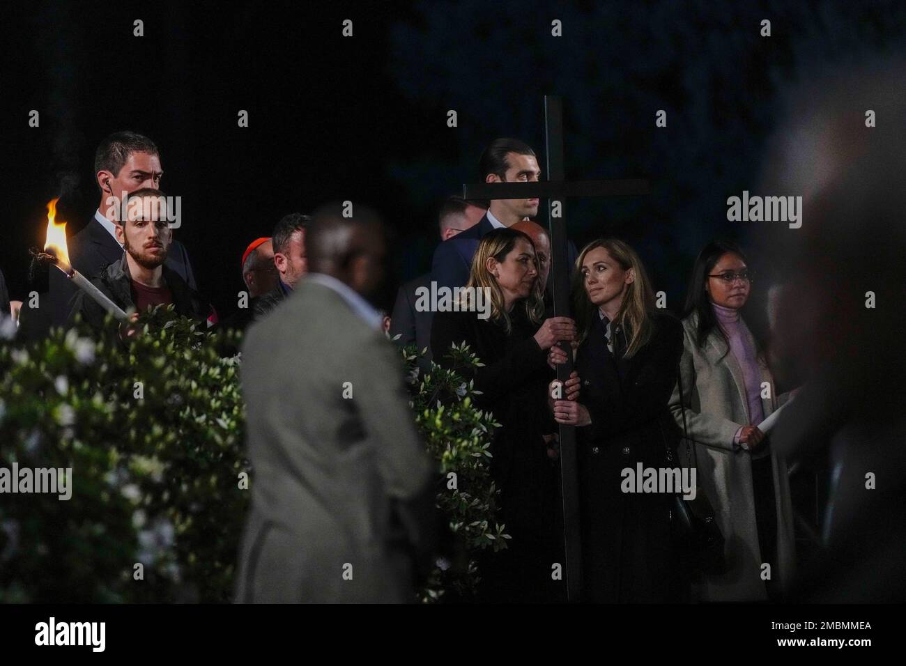 Two nurses from Russia and Ukraine hold the cross as they take part in ...