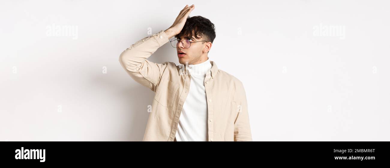 Portrait of annoyed stylish guy facepalm, roll eyes from something ...