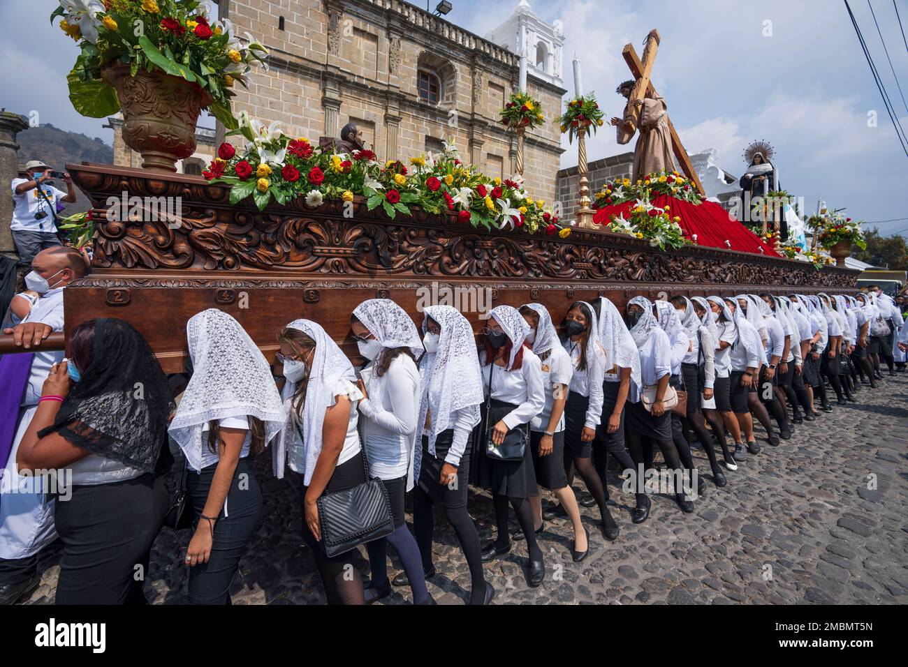 Women carry a statue of Jesus Christ on a religious float during a Holy ...