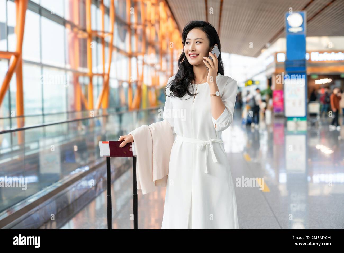 A young woman make a phone call at the airport Stock Photo - Alamy