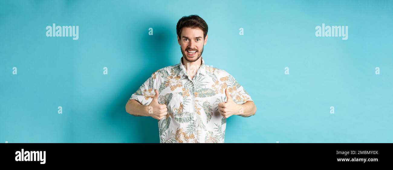 Handsome tourist showing thumbs up and say yes, praising good tourism ... Handsome tourist showing thumbs up and say yes, praising good tourism ...