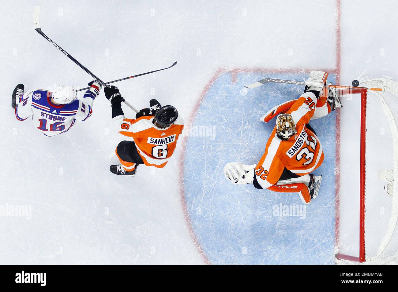 Philadelphia Flyers goaltender Felix Sandstrom, right, makes a save as ...