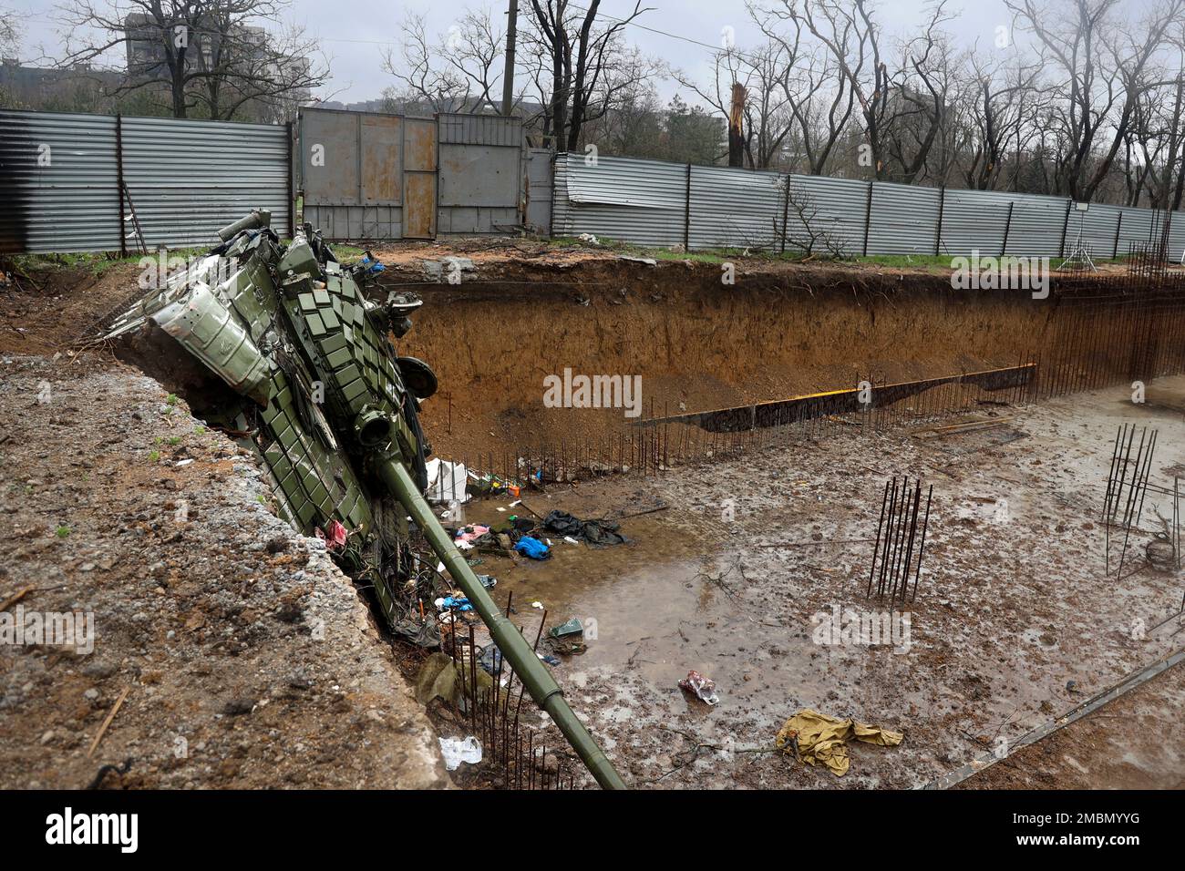 A tank damaged during fighting is seen at the foundation pit for a ...