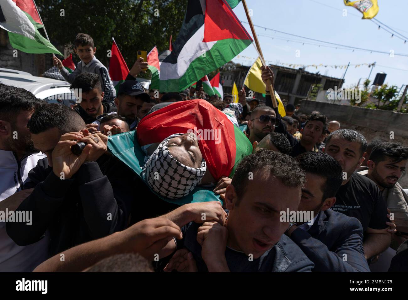 Palestinian mourners carry the body of Muhammad Assaf during his funeral in the West Bank ...