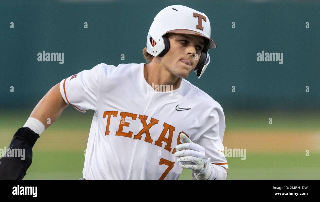 Texas center fielder Douglas Hodo III heads for home plate against ... Texas center fielder Douglas Hodo III heads for home plate against ...