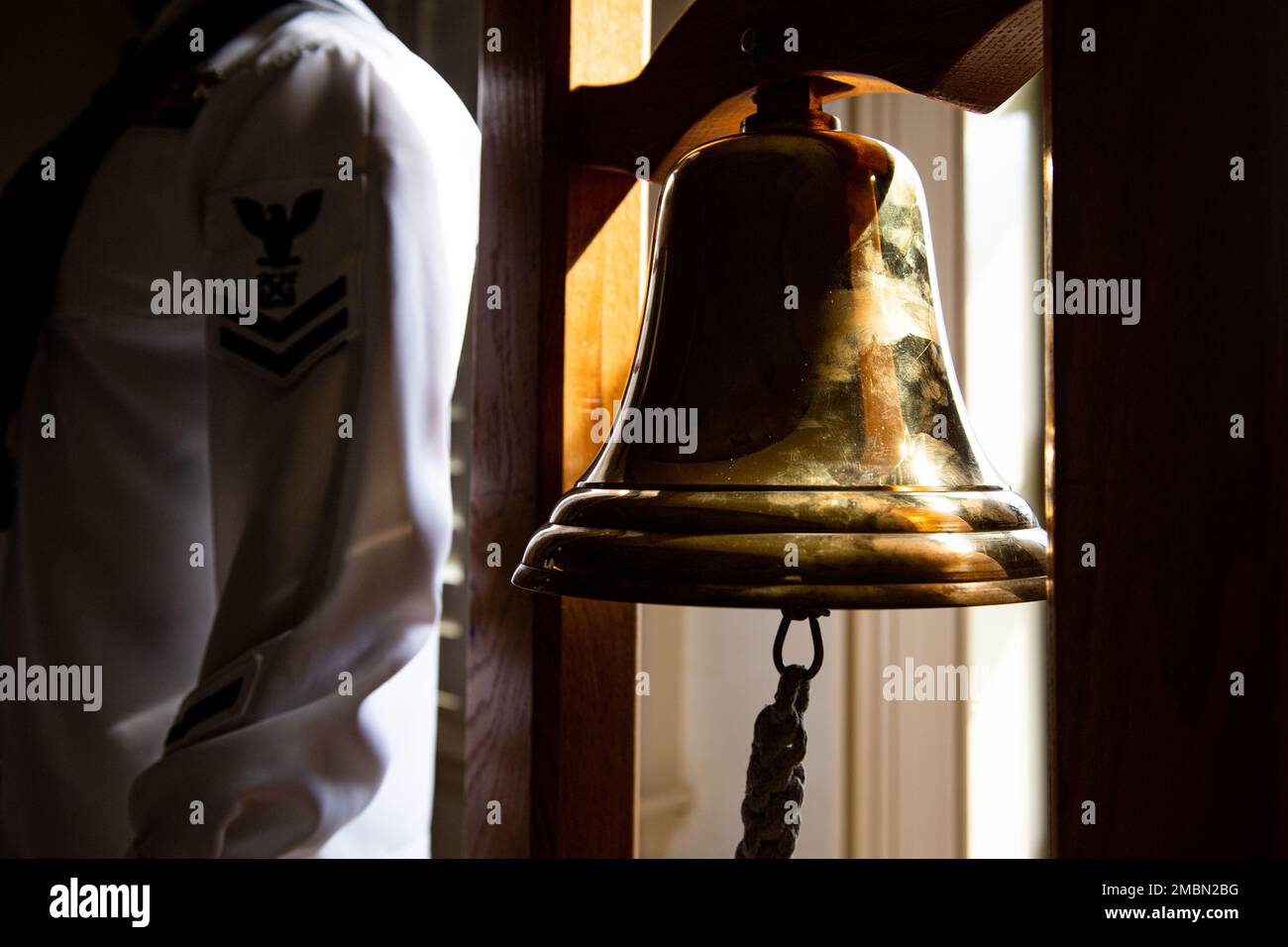 U.S. Navy Sailors ring a bell in recognition of the 628th Security ...