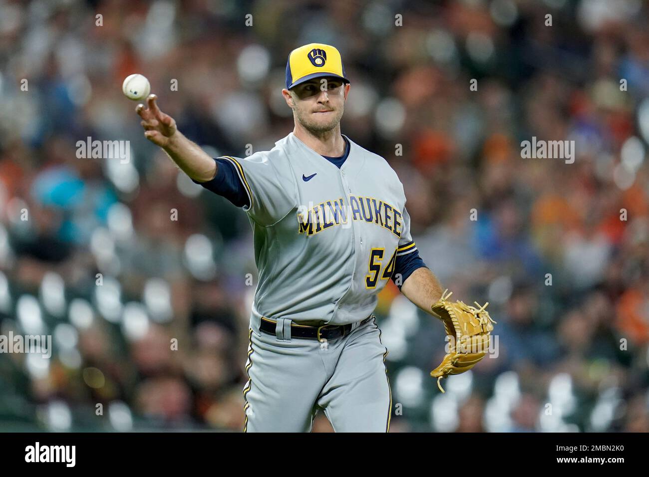 Milwaukee Brewers relief pitcher Jake Cousins throws to first base ...