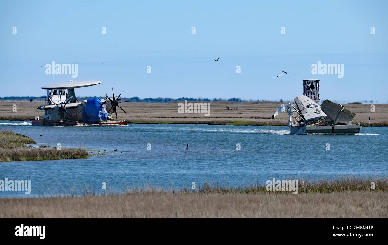 Barges, carrying what is left of a crashed Navy E2-D Advanced Hawkeye ...