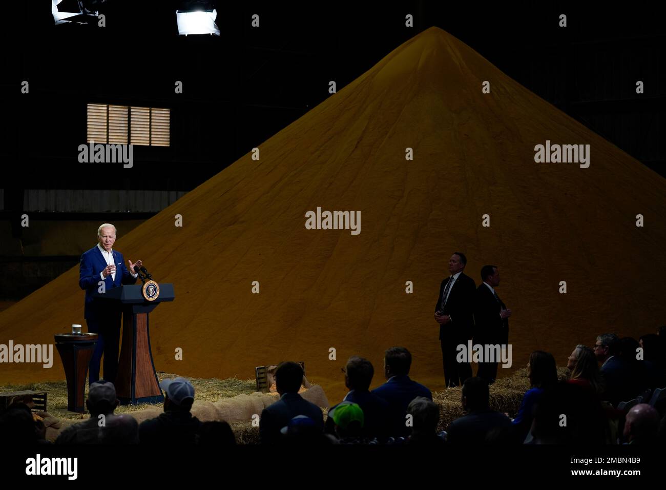 President Joe Biden speaks, with a pile of corn meal as a backdrop, at ...