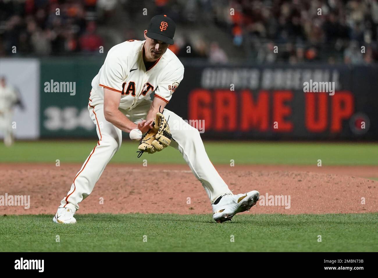 San Francisco Giants pitcher Tyler Rogers drops the ball on a ground out hit into by San Diego ...