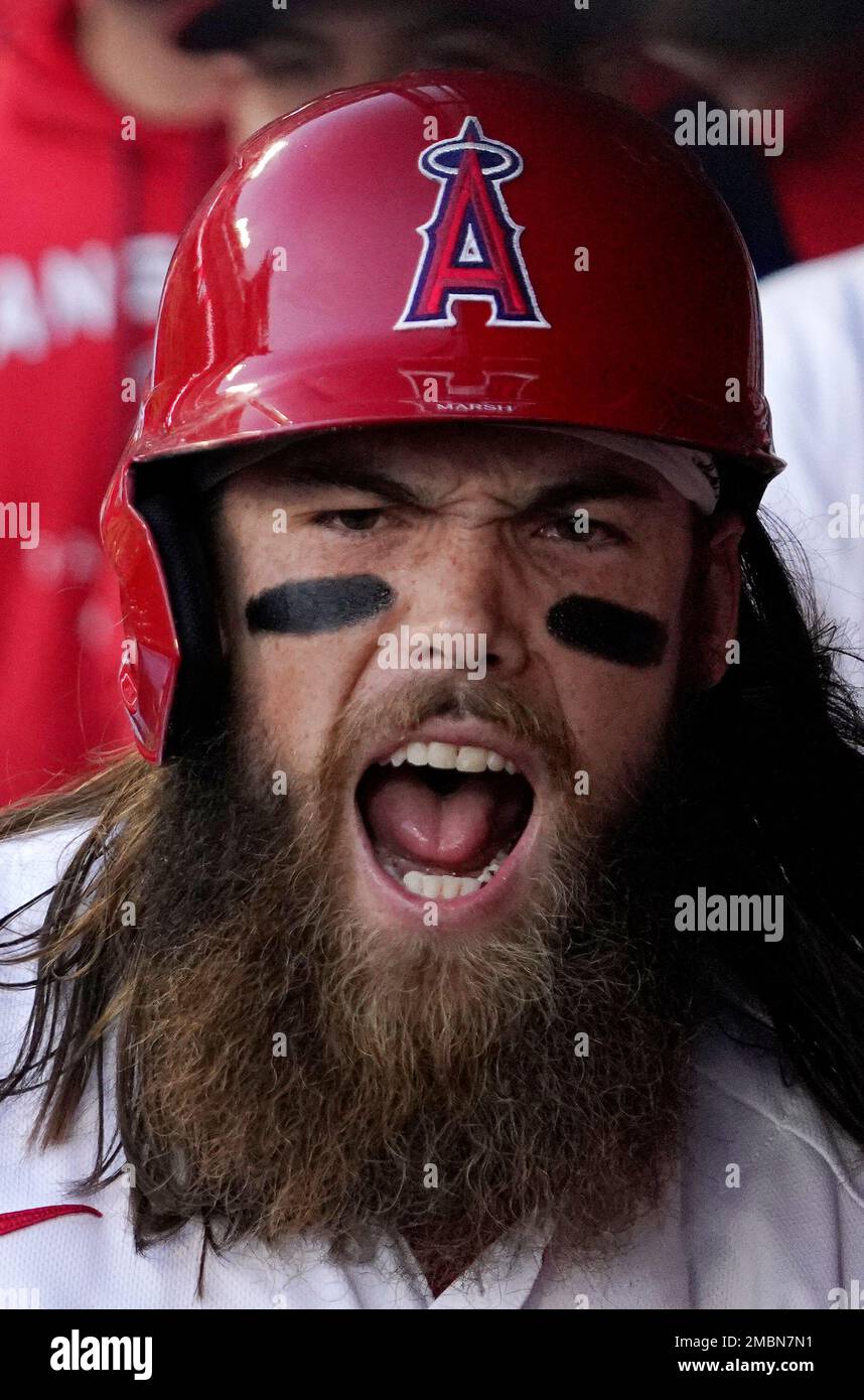 Los Angeles Angels' Brandon Marsh yells in the dugout after hitting a ...