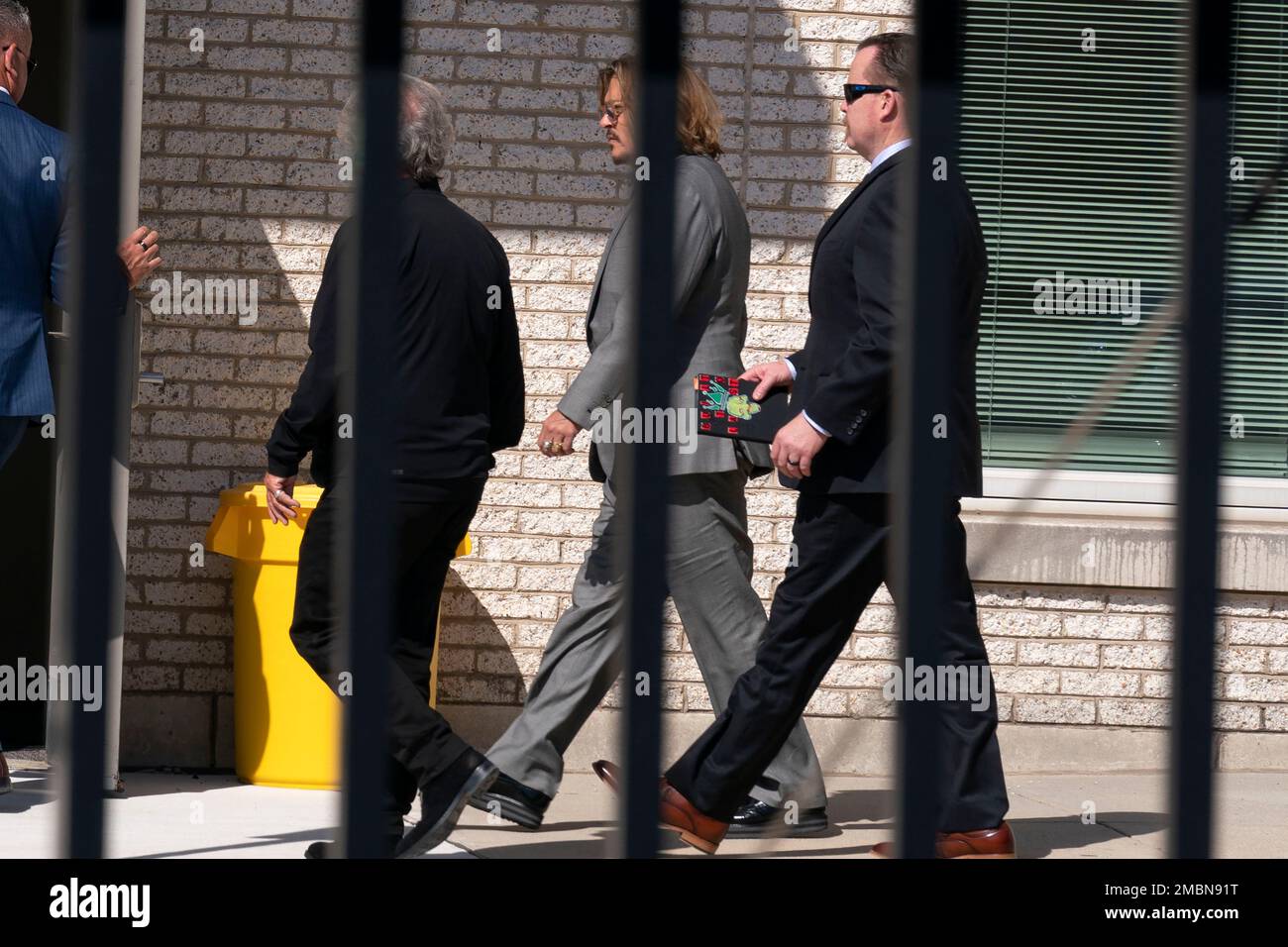 Actor Johnny Depp, center left, leaves the Fairfax County courthouse ...