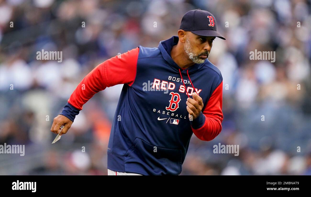 Boston Red Sox manager Alex Cora runs back to the dugout after ...