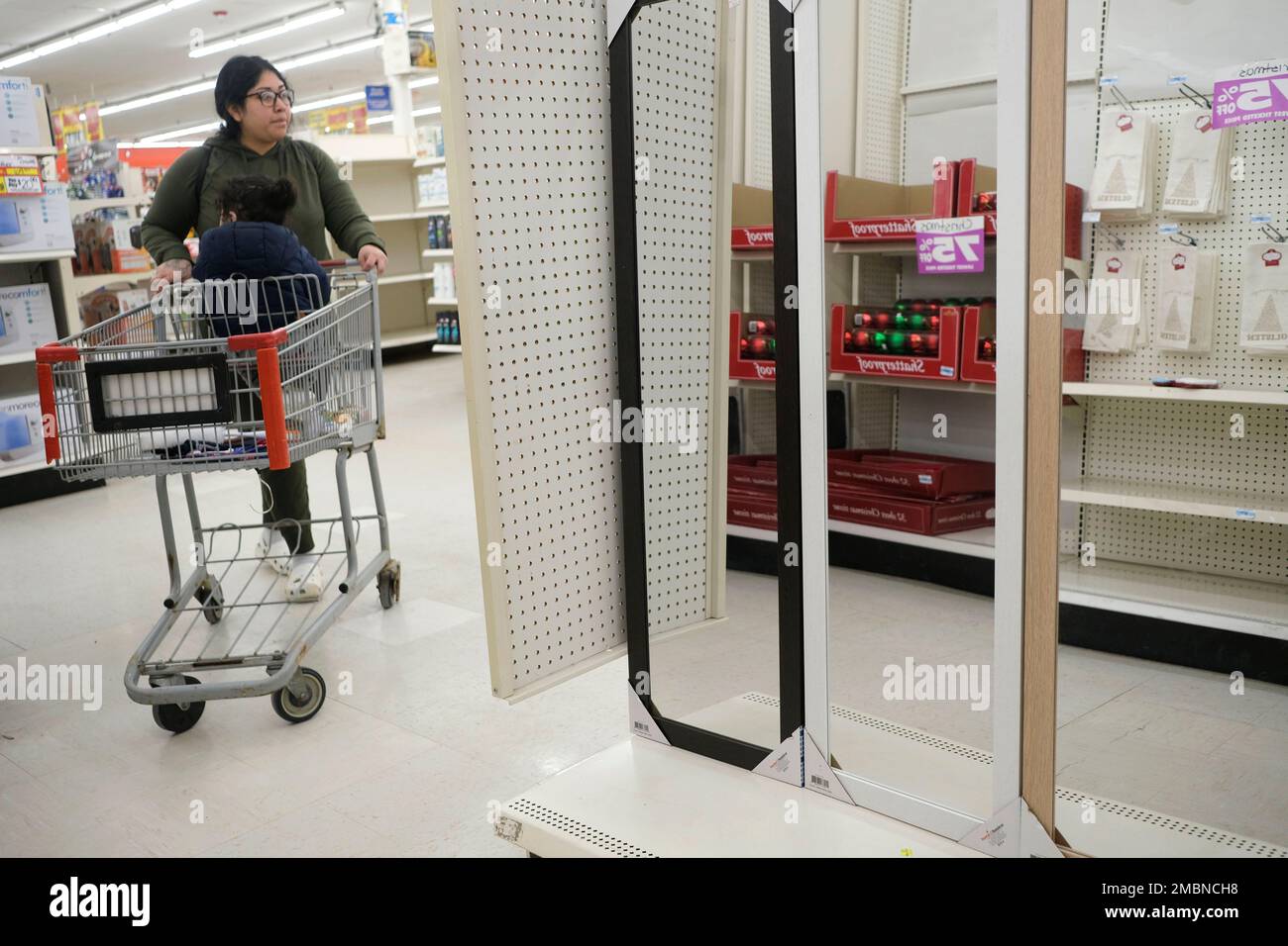 People shop the half-empty shelves of the Kmart in Avenel, N.J., Monday ...