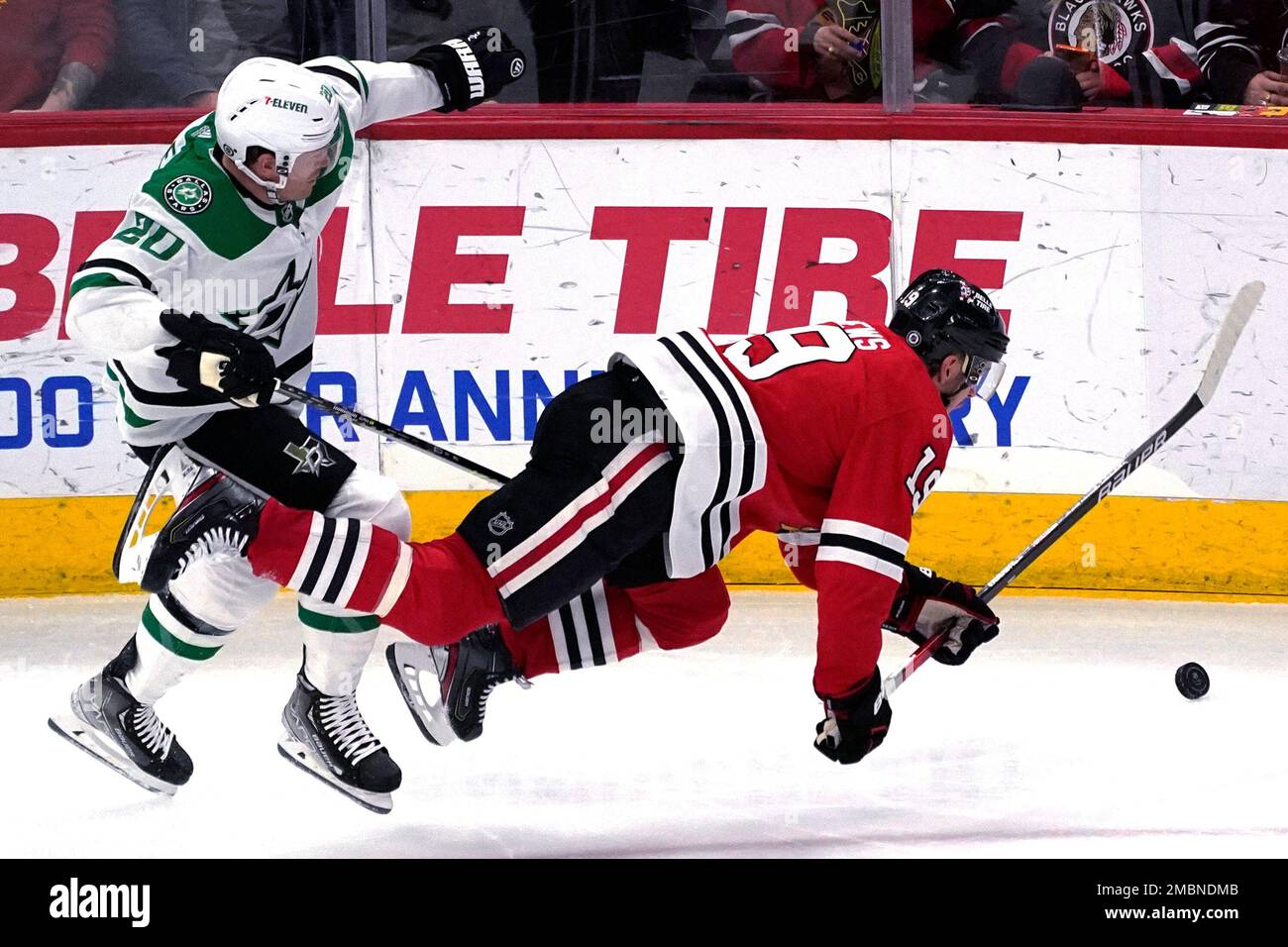 Chicago Blackhawks center Jonathan Toews, right, is checked by Dallas ...
