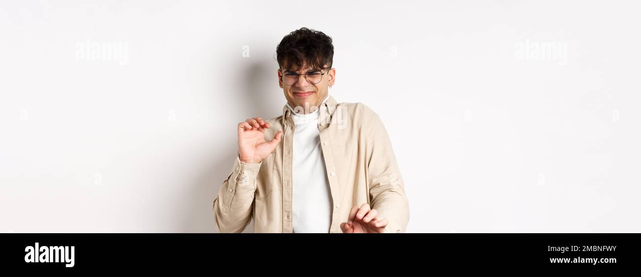 Disgusted guy grimacing and jumping away from something nasty, stare ...